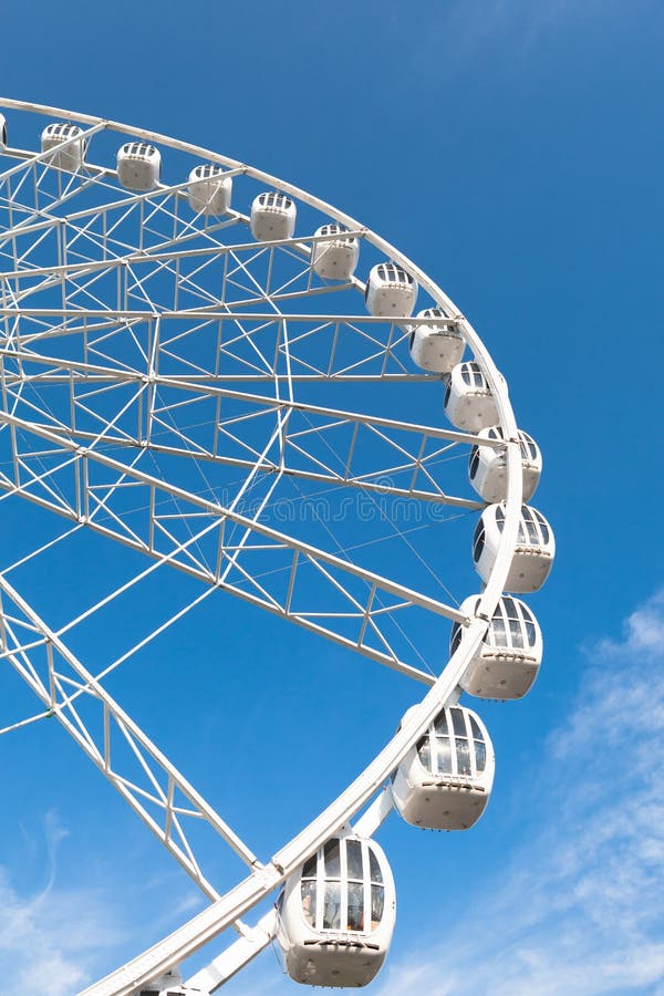 White Ferris Wheel with Glass Light Blue Cabins Against Blue Sky, Dubai ...