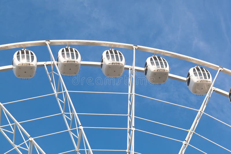 White Ferris Wheel with Glass Light Blue Cabins Against Blue Sky, Dubai ...