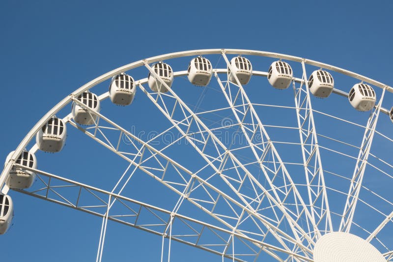 White Ferris Wheel with Glass Light Blue Cabins Against Blue Sky, Dubai ...