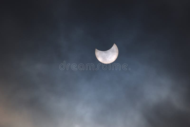Partial Eclipse of the Sun on a Cloudy Sky Stock Photo - Image of ...