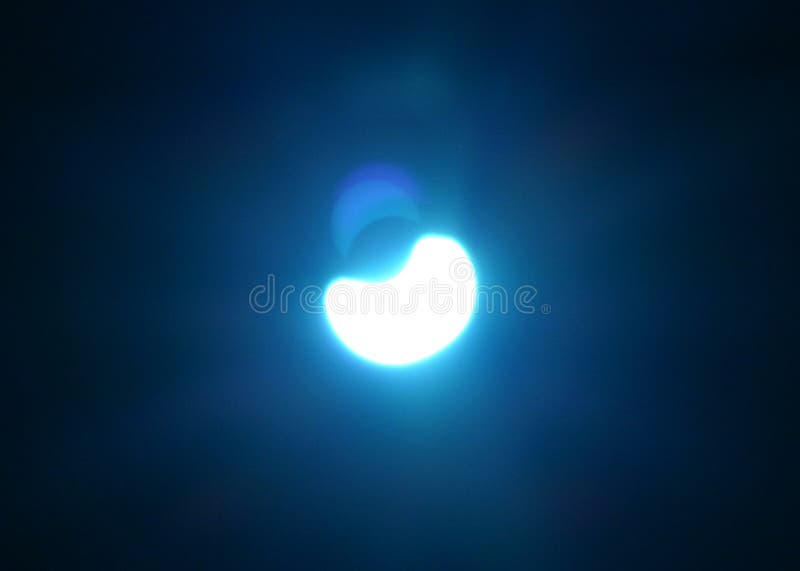 Partial Eclipse of the Sun on the Dark Blue Background Stock Image ...