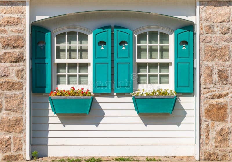 Partial Front Exterior Of White Cottage With Teal Shutters And Window ...