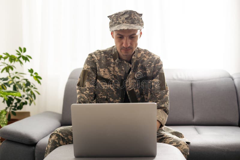 Partial View of Army Soldier Using Laptop on Couch Stock Photo - Image ...