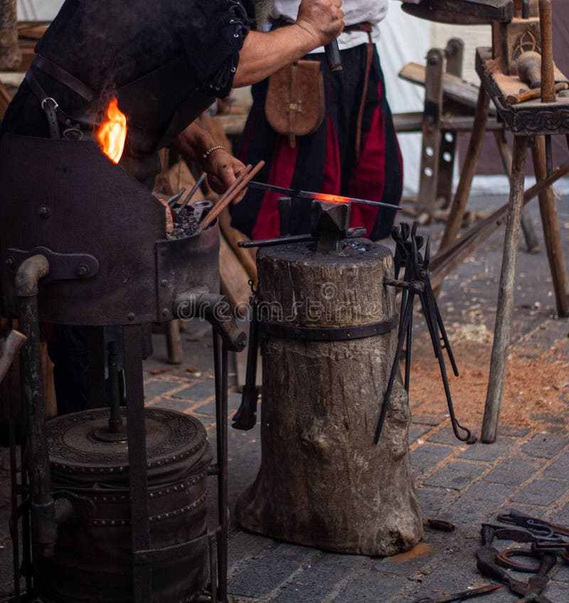 Partial View of a Blacksmith Shaping the Hot Metal in His Smithy Stock ...
