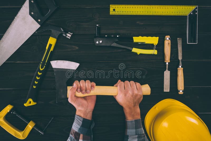 Partial View of Carpenter Holding Axe with Various Industrial Tools ...