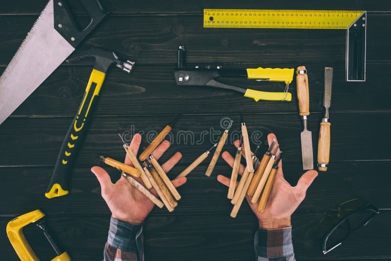 Partial View of Carpenter Holding Chisels with Various Industrial Tools ...