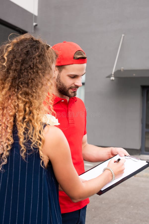 Partial View of Client Signing Document on Notepad in Delivery Stock ...