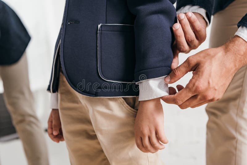 View of Dad Helping Son To Get Dressed at Home Stock Photo - Image of ...