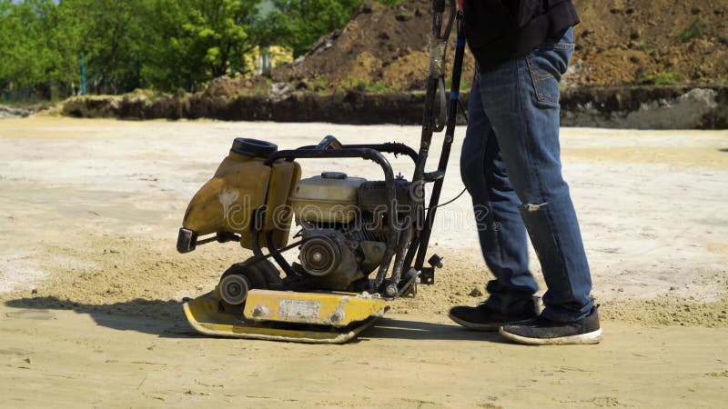 Partial View of Man Ramming Sand with Surface Plate Vibrator in ...