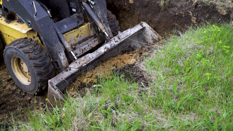 Partial View of Mini Loader Removing Layer of Grassy Soil at Earth ...