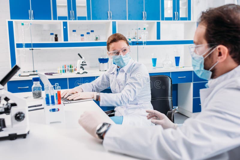 Partial View of Scientists Having Discussion at Workplace Stock Photo ...