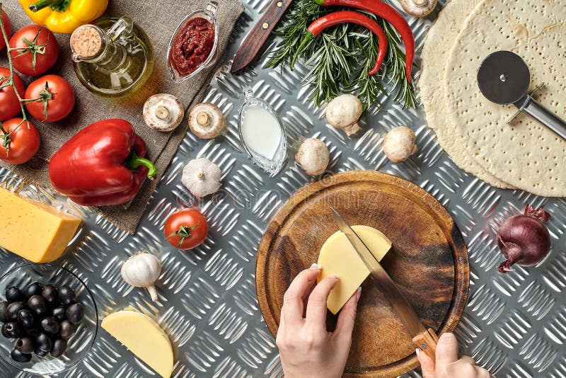 Partial View of Woman Cutting Cheese while Cooking Homemade Italian ... Partial View of Woman Cutting Cheese while Cooking Homemade Italian ...