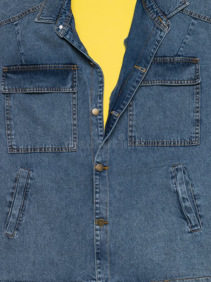 Partially Buttoned Denim Jacket on a Yellow Background Stock Photo ...