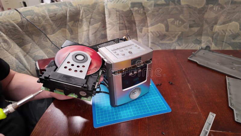 Repairing a CD Player with Exposed Mechanism on a Table Stock Footage ...