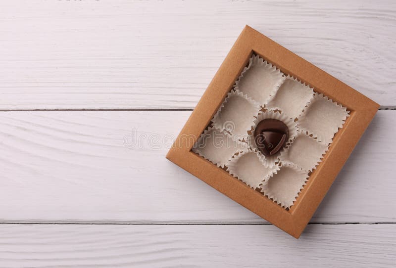 Partially Empty Box of Chocolate Candies on White Wooden Table, Top ...