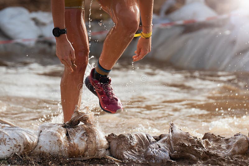 Participant in an Obstacle Course Race Runs Out of a Water Obstacle ...