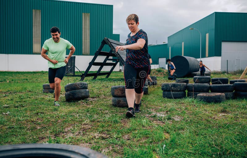 Participants in an Obstacle Course Dragging Wheels Stock Photo - Image ...