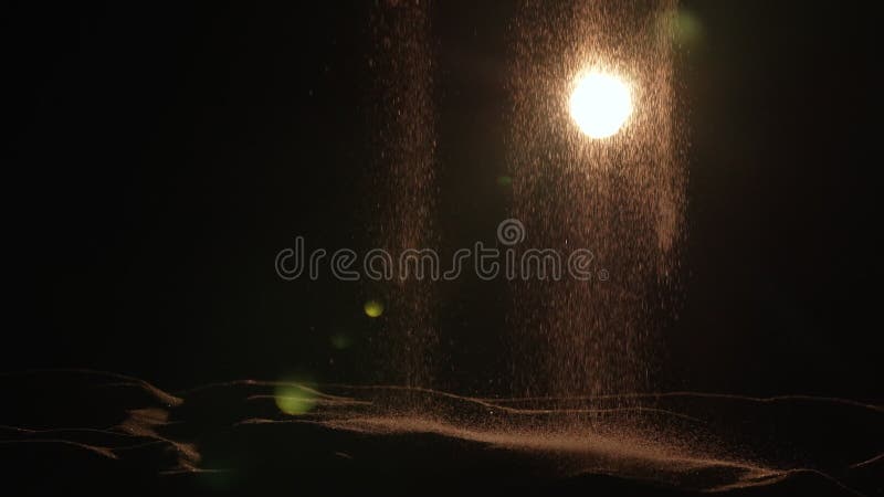 Particles of Dry Sand are Pouring Down on Black Studio Background with ...
