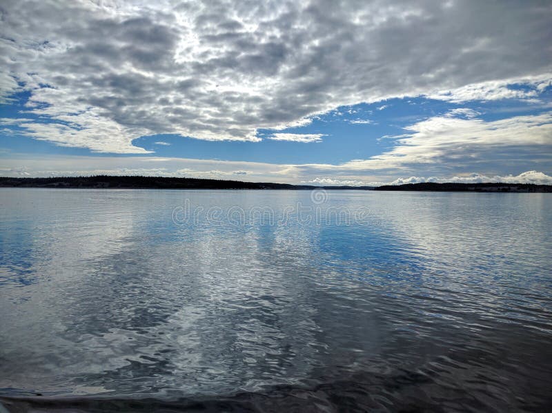 Partly Cloudy Sky Reflecting in the Ocean Stock Image - Image of ...