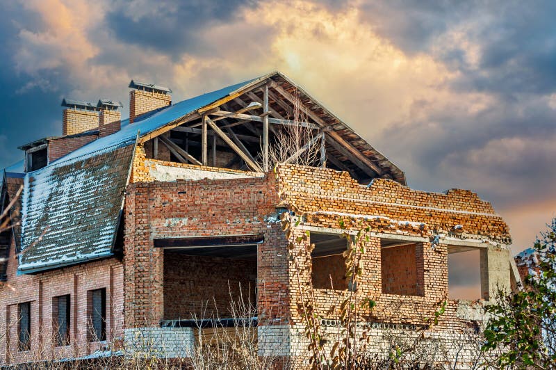 A Partly Demolished Brick Building Shows the Effects of Time, with ...