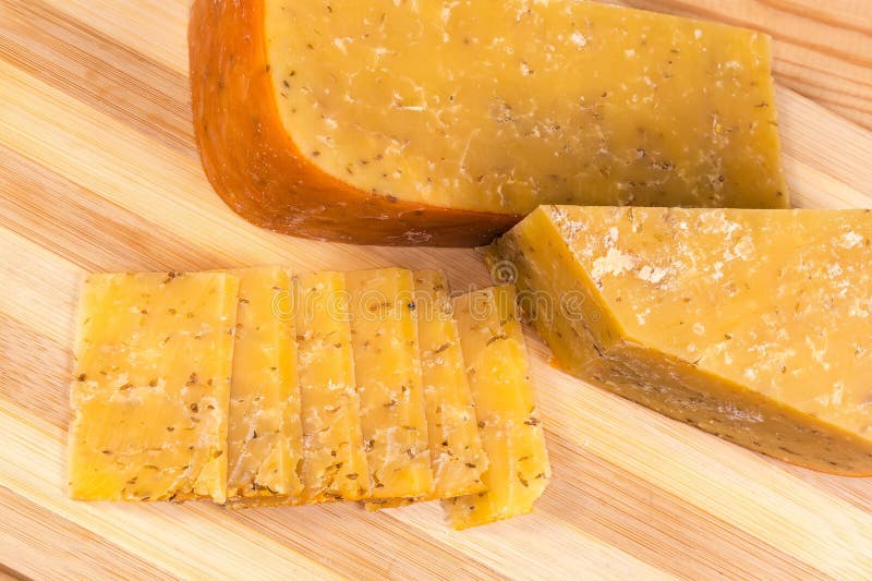 Partly Sliced Hard Cheese with Adding Cumin on Cutting Board Stock ...