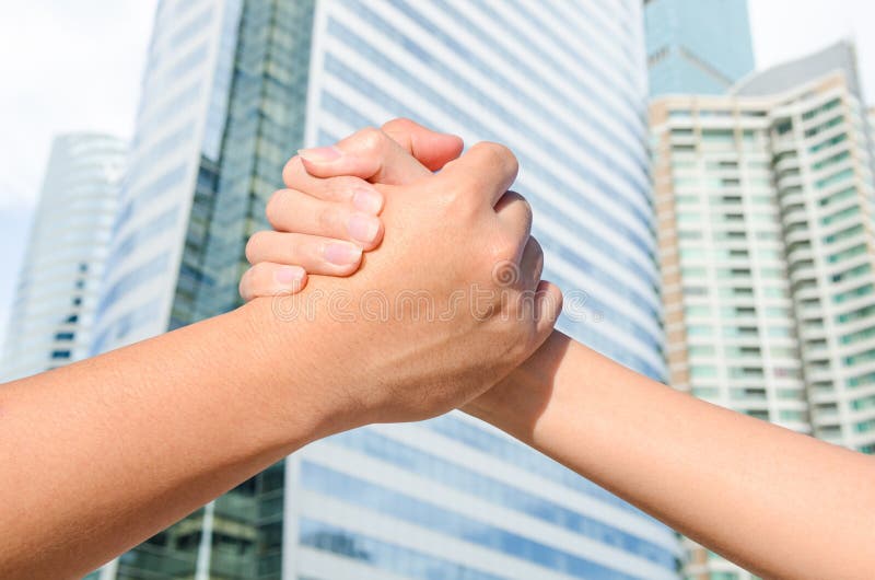 Partner Hand between a Man and a Woman on Building Background Stock ...