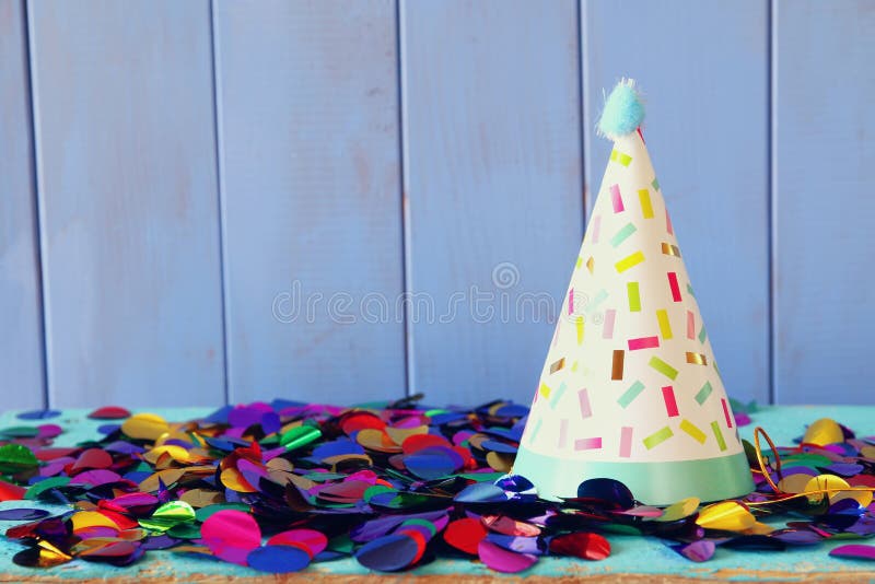 Party Hat and Colorful Confetti on Wooden Table. Stock Photo - Image of ...