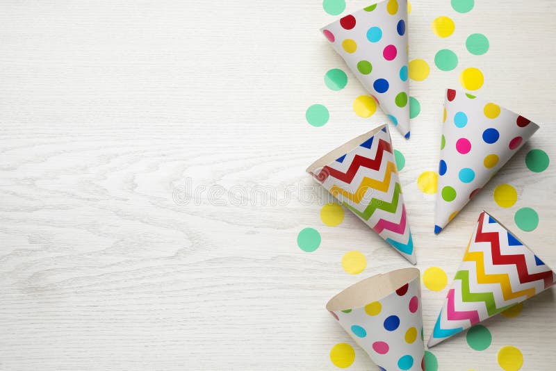 Party Hats and Confetti on White Wooden Table, Space for Text Stock ...