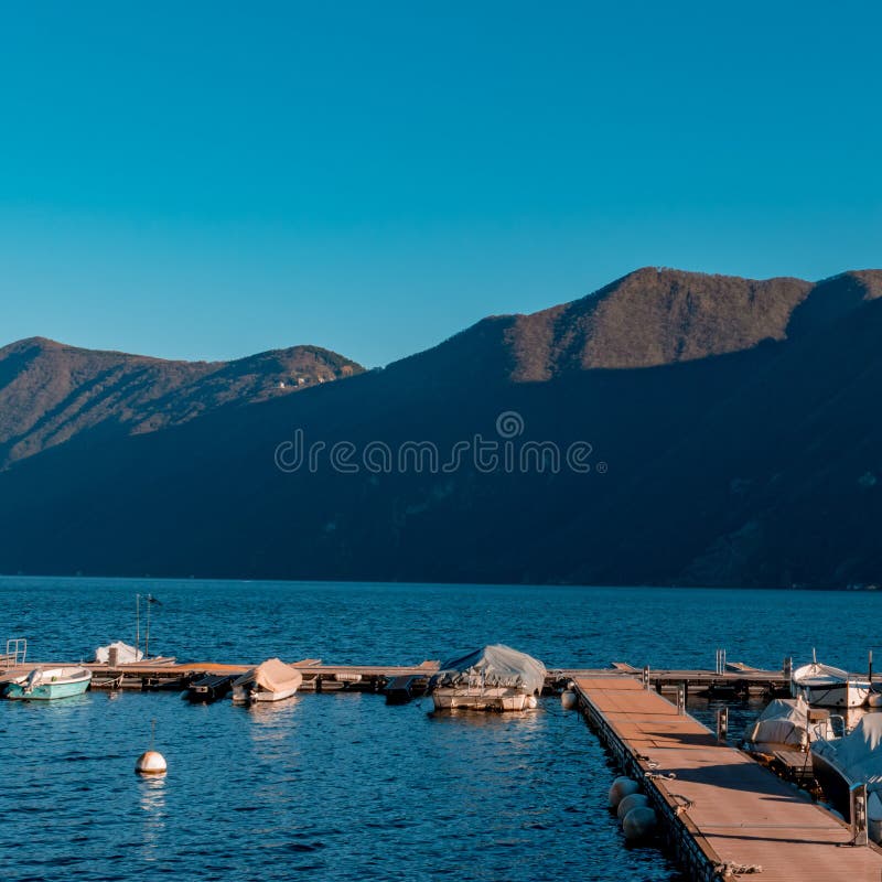 Passage of a Lake with Jetty and Mountains Stock Photo - Image of lake ...