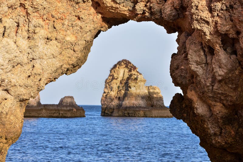 Passageway Created through the Cliff Over the Water Stock Image - Image ...