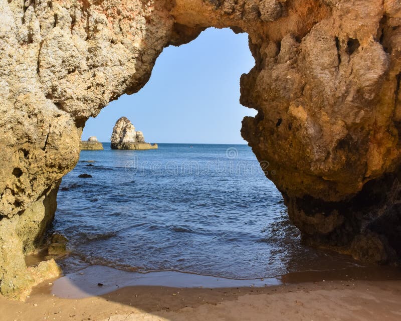 Passageway Created through the Cliff Over the Water Stock Image - Image ...
