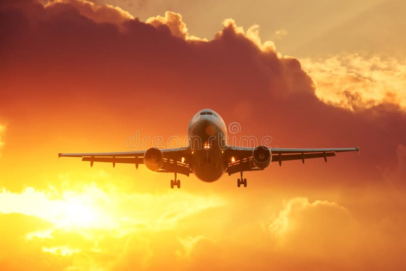 Passenger Airplane Flight Approach in the Clouds at Sunset Stock Image ...