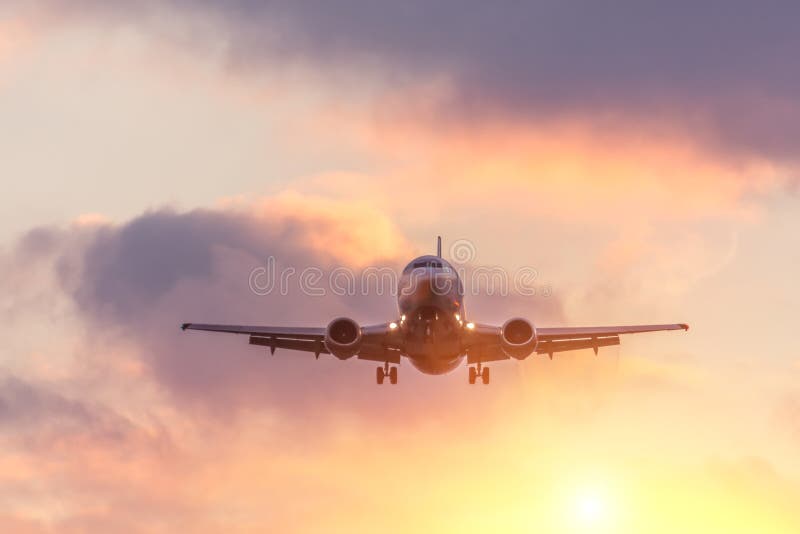 Passenger Airplane Flight Approach in the Clouds at Sunset Stock Image ...