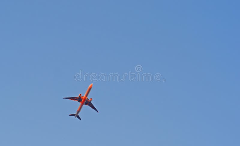 The Passenger Airplane is Flying Far Away in Blue Sky. Stock Photo ...