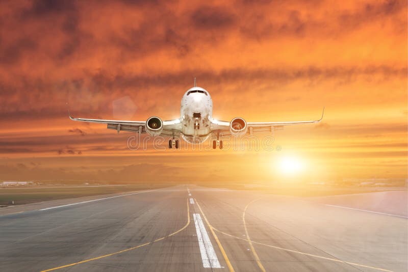 Passenger Airplane Landing at Sunset on a Runway. Stock Image - Image ...