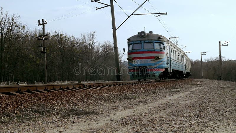 Blue Train with White Stripes Passes through Rural Fields Stock Video ...