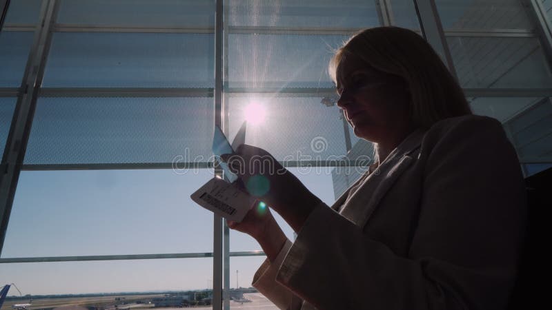 A Passenger with a Boarding Pass in His Hands is Standing at a Large ...