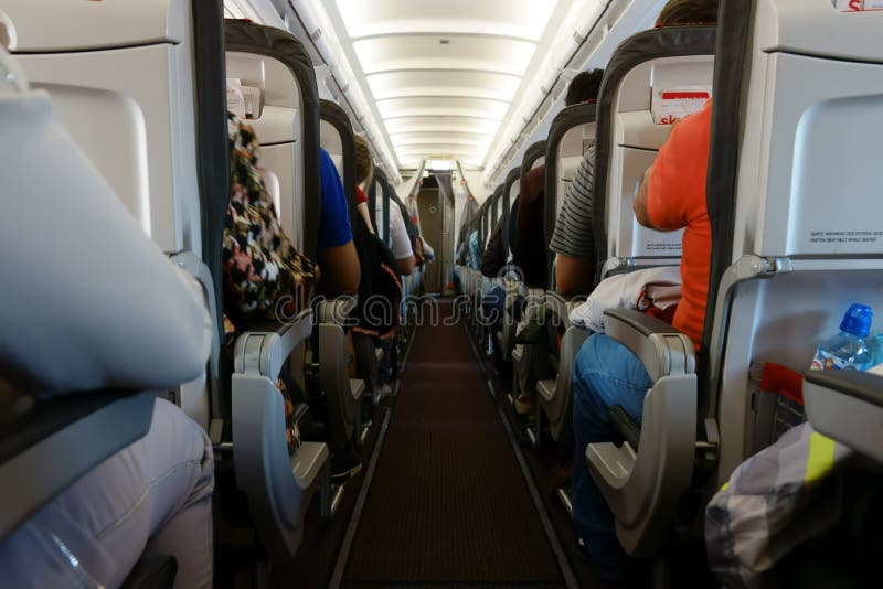 Passenger Cabin in Flight with People. Economy Class. View from the ...