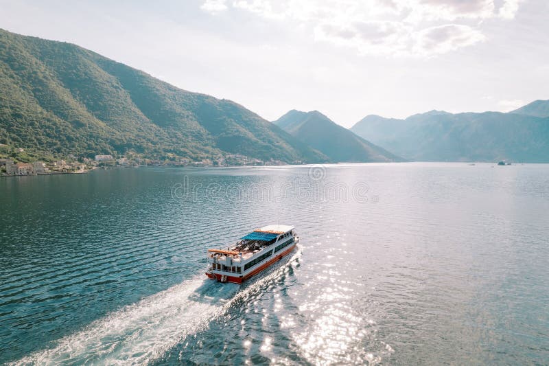 Passenger Excursion Ship Sails Along the Bay with a Mountain Range in ...