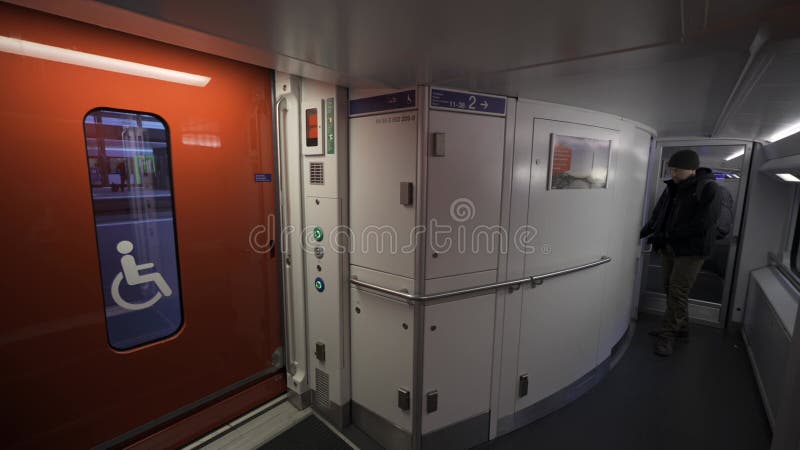 A Passenger Exits the Restroom Aboard a Stationary Swiss Double-decker ...