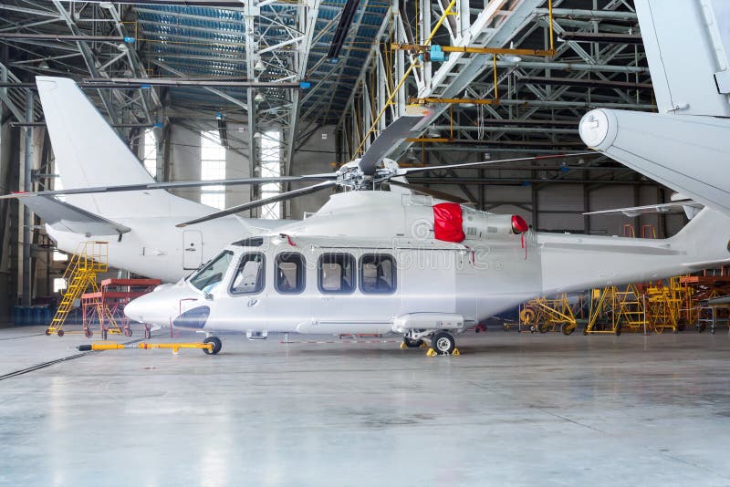 Passenger Helicopter in the Hangar. Rotorcraft Under Maintenance ...