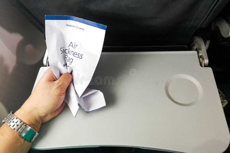 Passenger Holding Air Sickness Vomit Bag in Airplane Stock Photo ...