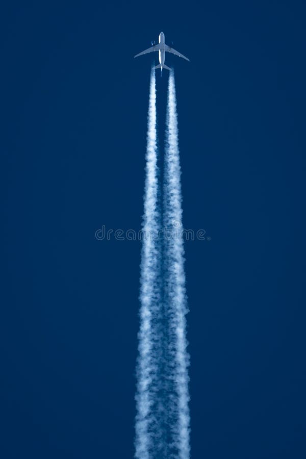 Passenger Jet Flies Overhead with Jet Stream Portrait View with Deep ...