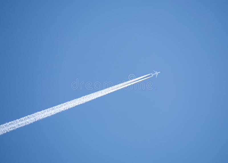 Passenger Jet Flying in Clear Blue Sky, Leaving White Trail Stock Image ...