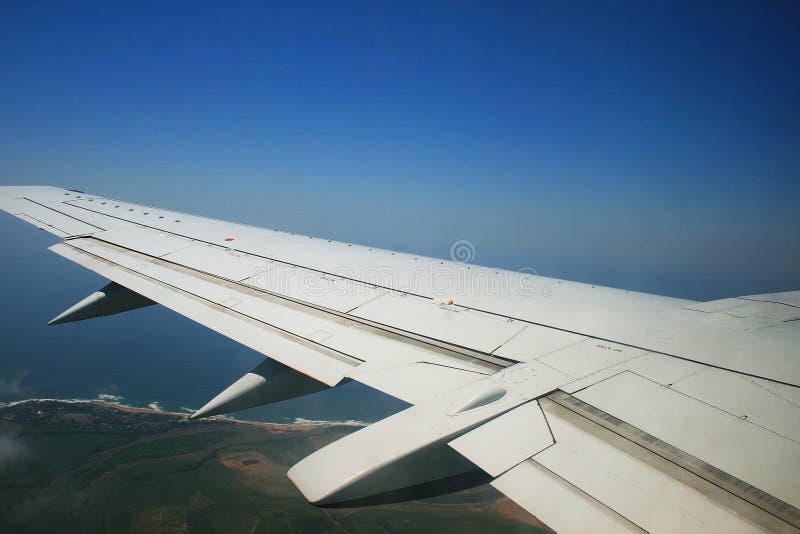 PASSENGER JET WING ABOVE TERRAIN in FLIGHT. Stock Image - Image of ...