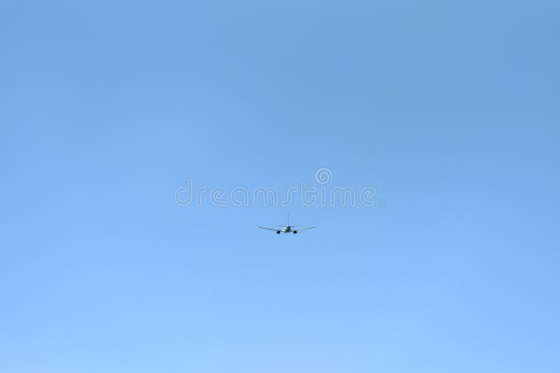 The Passenger Plane Flies Away into the Blue Sky. Back View Stock Image ...