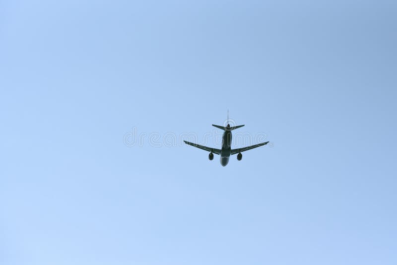 The Passenger Plane Flies Away into the Blue Sky. Back View Stock Photo ...