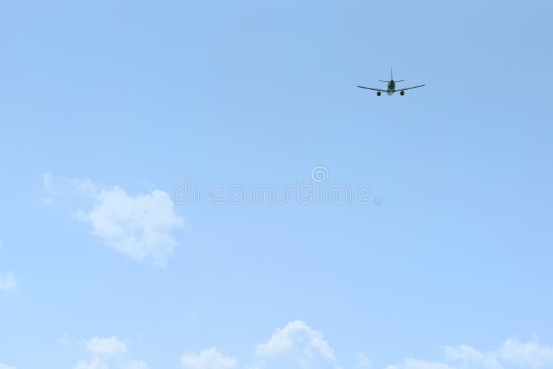 The Passenger Plane Flies Away into the Blue Sky. Back View Stock Image ...