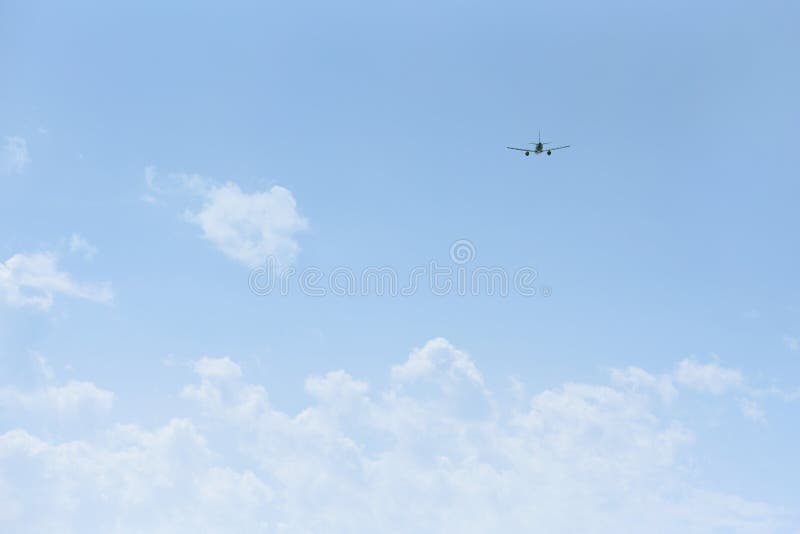 The Passenger Plane Flies Away into the Blue Sky. Back View Stock Image ...