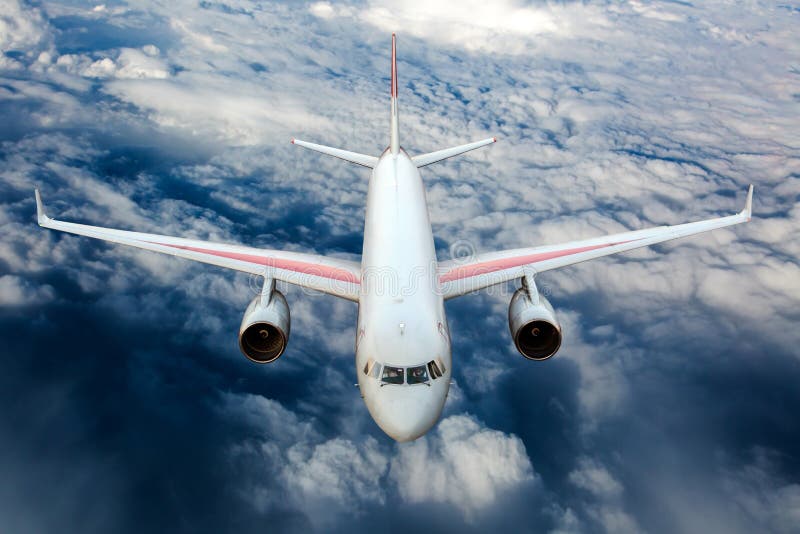Passenger Plane Fly High in the Sky Above the Clouds. Front View Stock ...